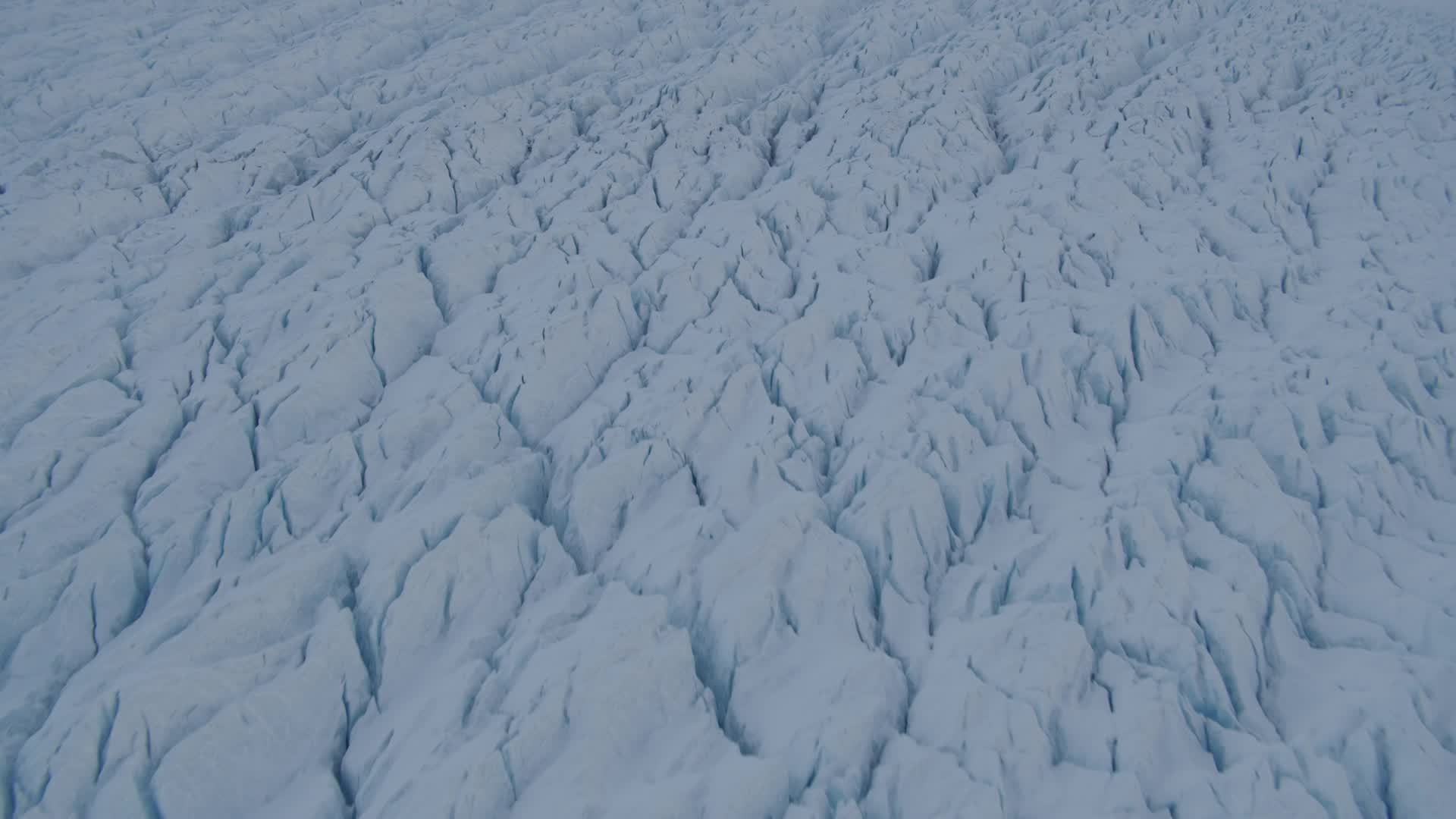 4K stock footage aerial video the cracked, snow covered surface of the ...