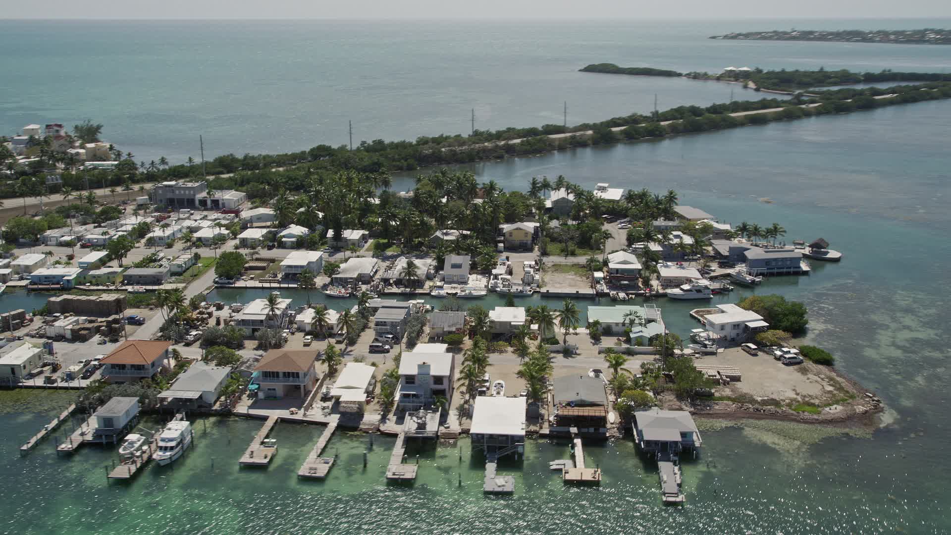 5K stock footage aerial video of flying by small neighborhood on Conch ...