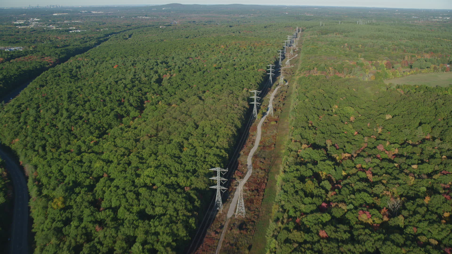 6k stock footage aerial video flying by deciduous forest, power lines ...