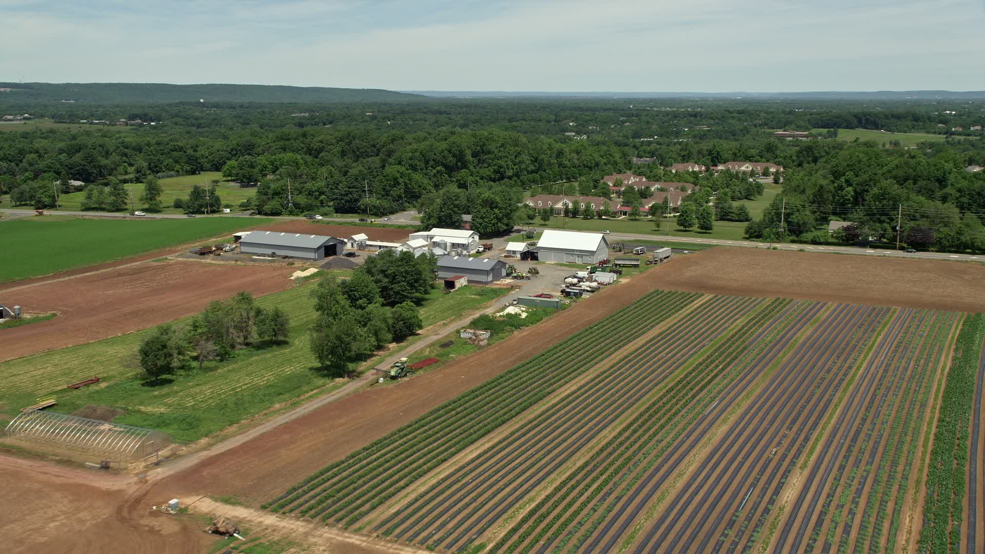 4.8K stock footage aerial video of a farm and crop field by a country ...