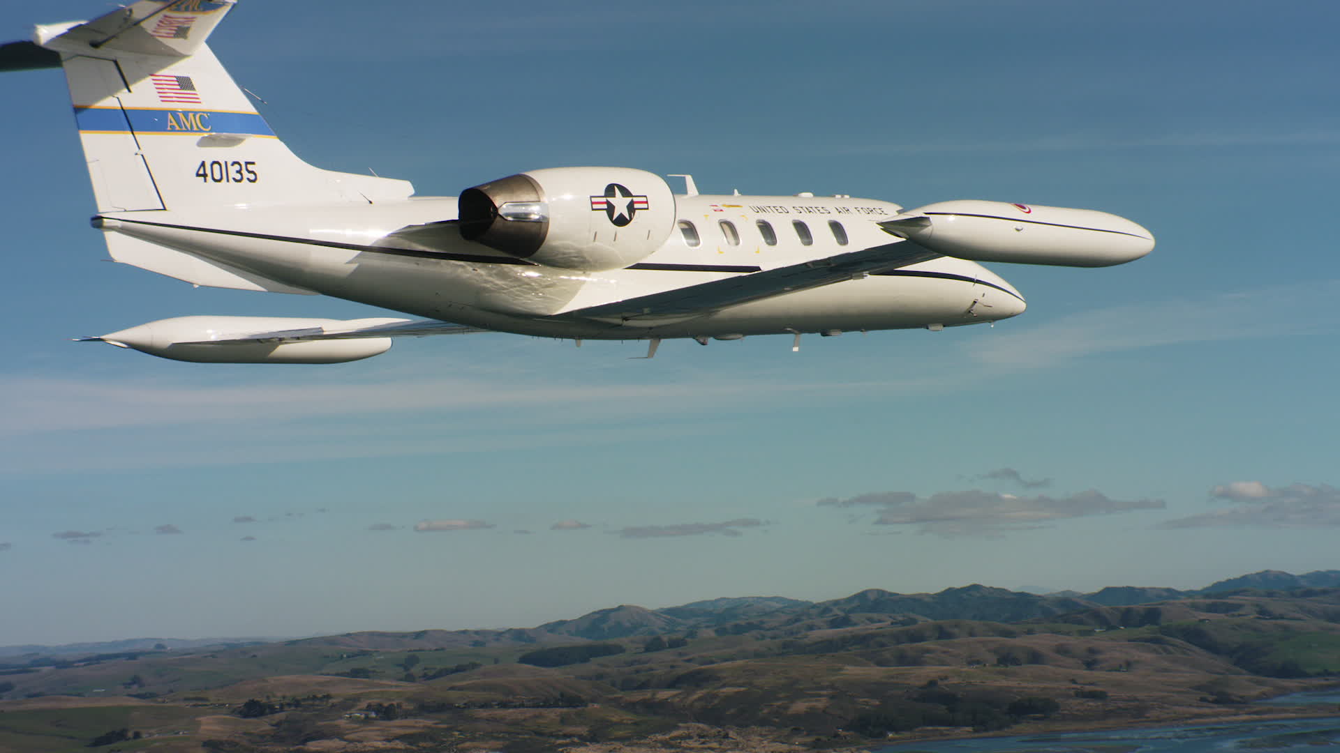 4K stock footage aerial video of following a Learjet C-21 flying along ...