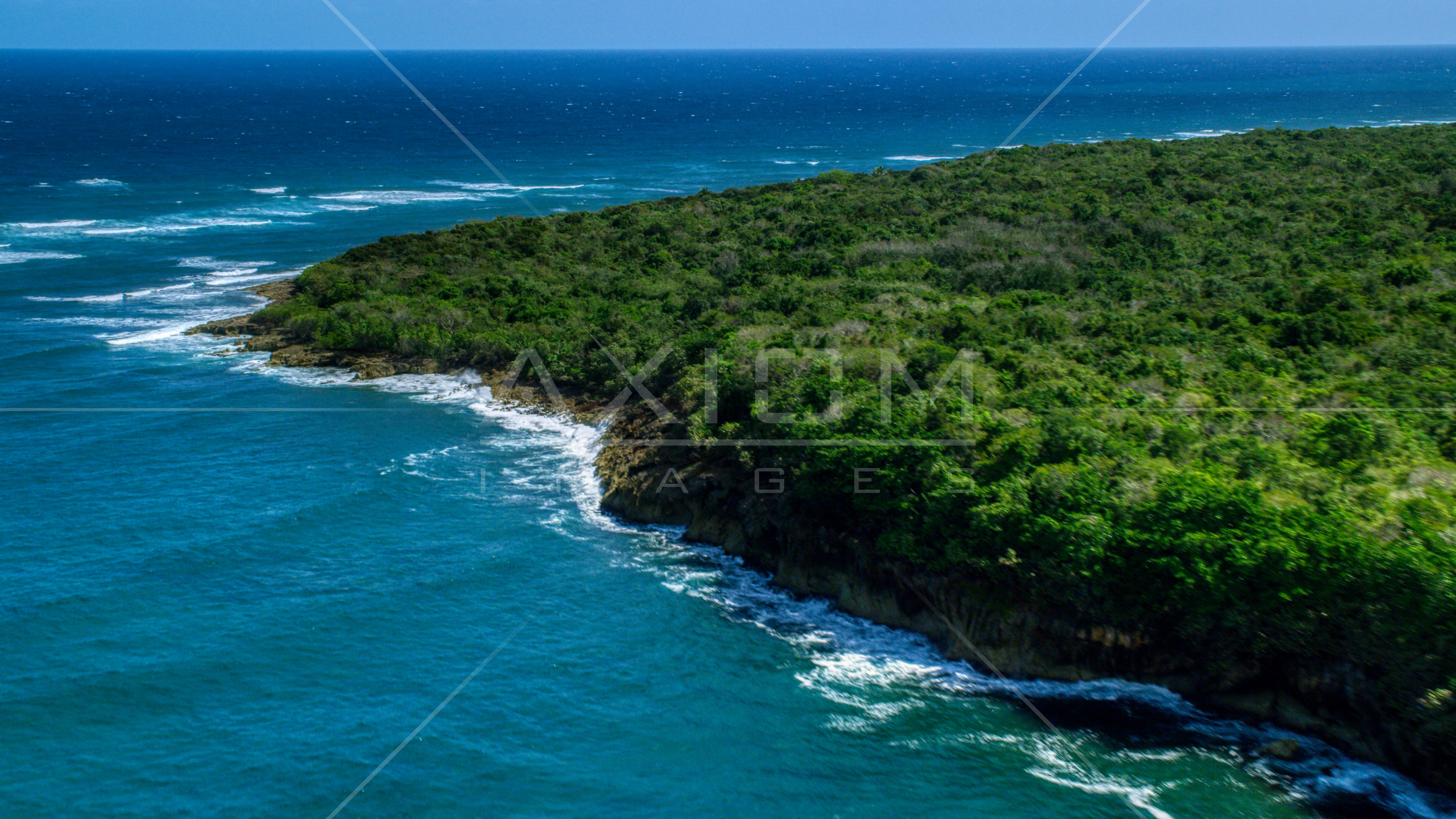 Stunning blue waters along a tree lined coast, Manati, Puerto Rico ...